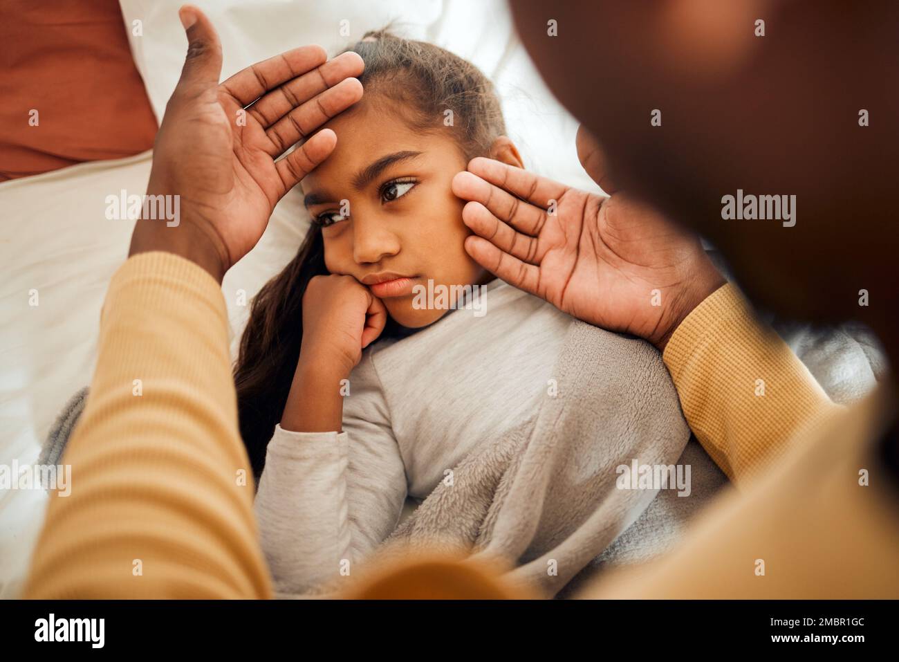 Sick, girl and father checking high temperature with hands on ill kid or daughter lying on a bed ...