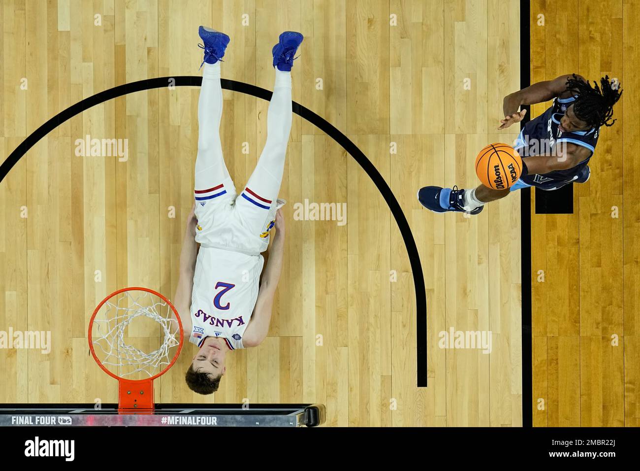 Villanova forward Brandon Slater shoots over Kansas guard Christian ...