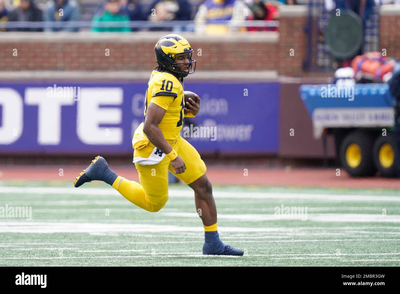 Michigan quarterback Alex Orji rushes during an NCAA college football ...