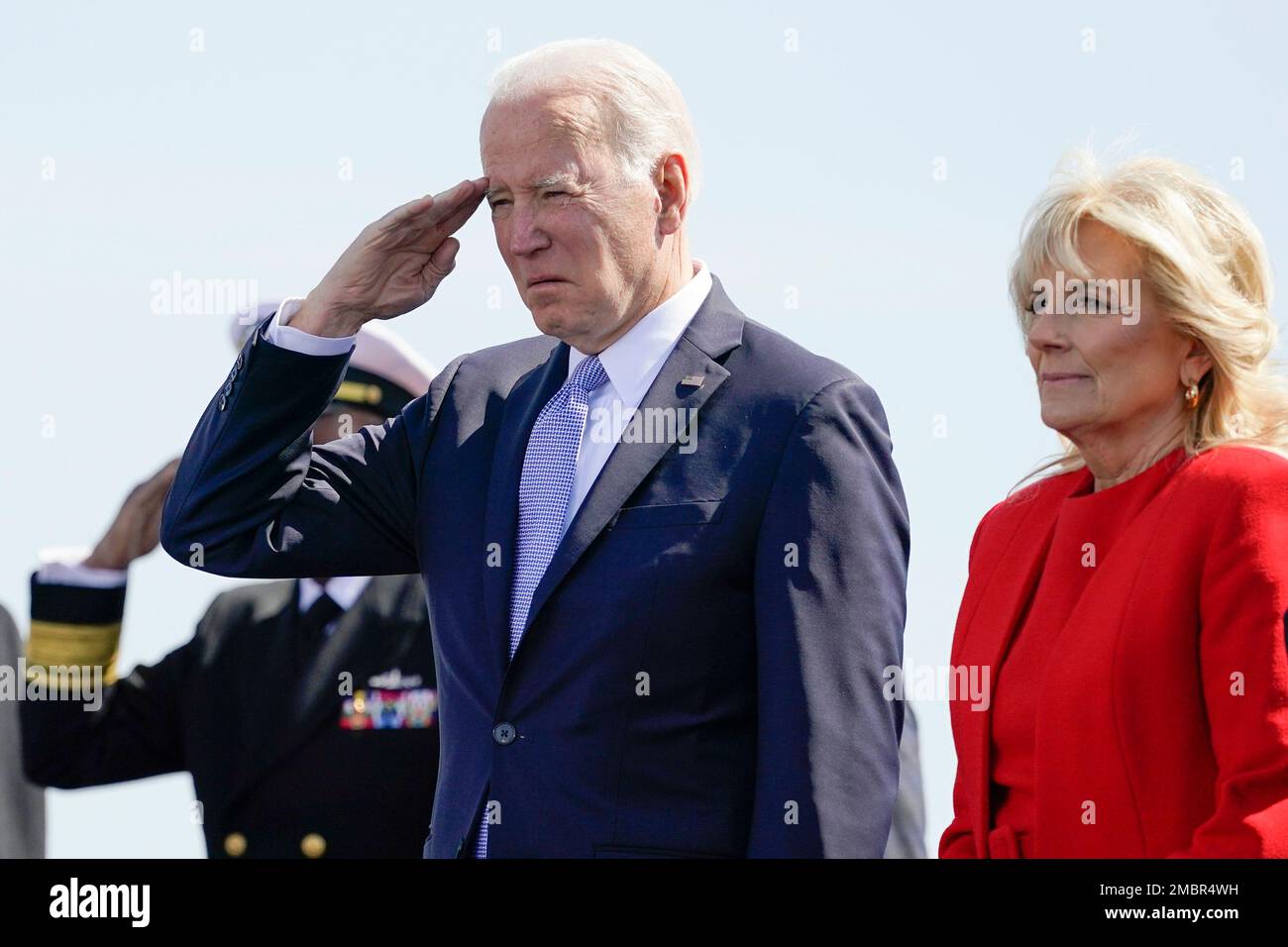 President Joe Biden and first lady Jill Biden stand during a 21-cannon ...