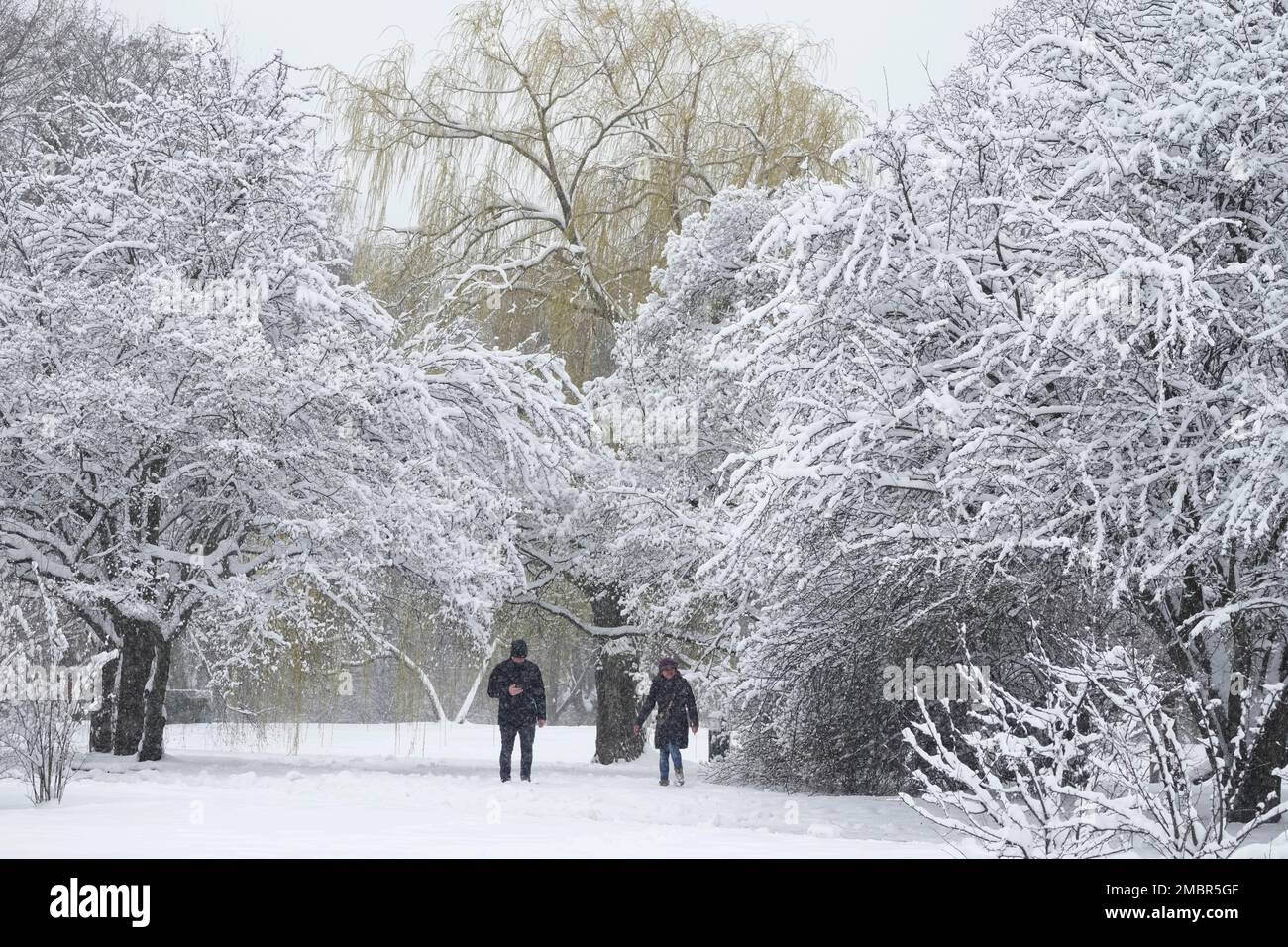 People walk in a park during a snowfall in Warsaw, Poland, Saturday ...