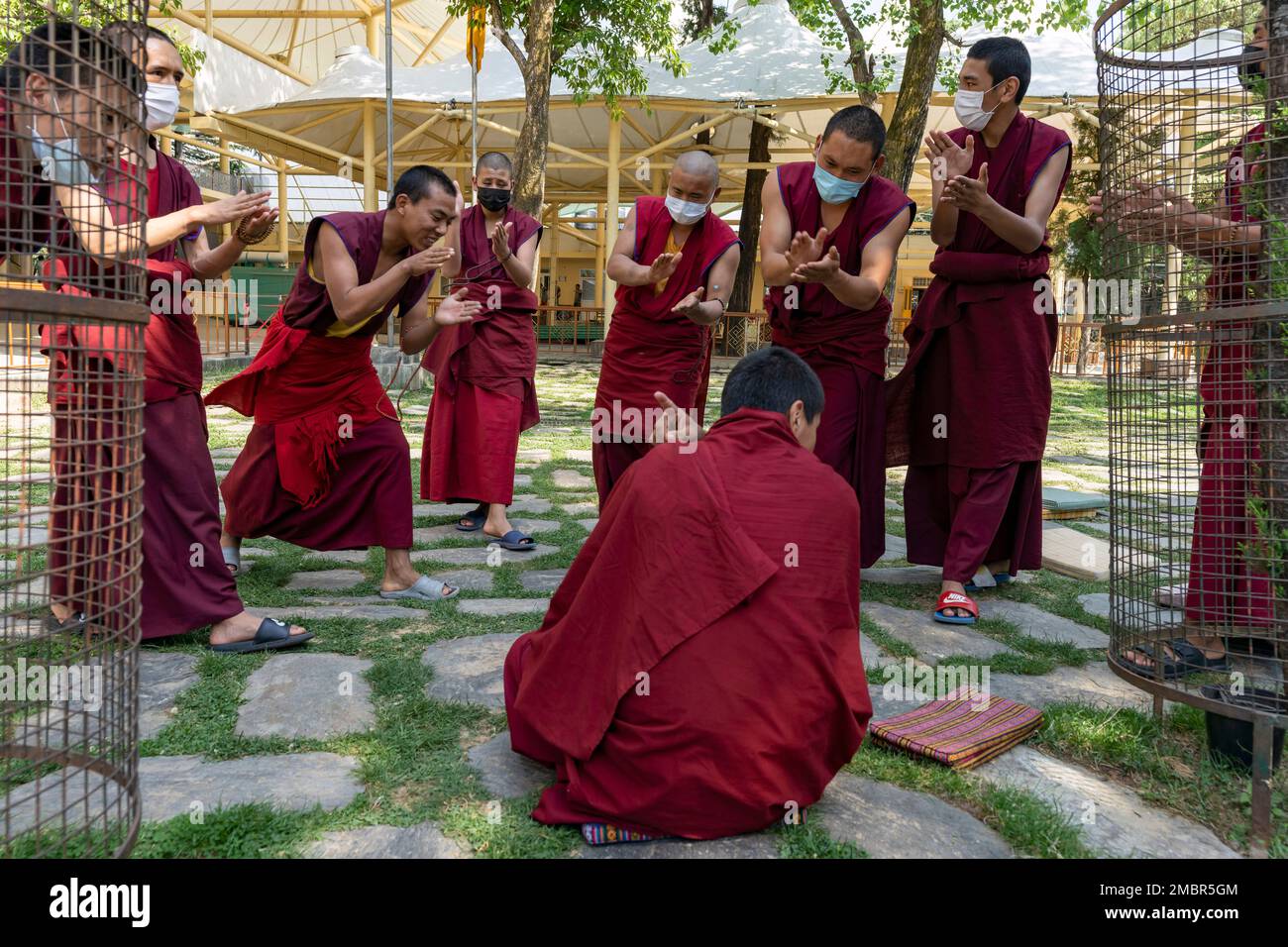 Monk students of Tibetan Buddhist dialectics gesture as they debate in ...