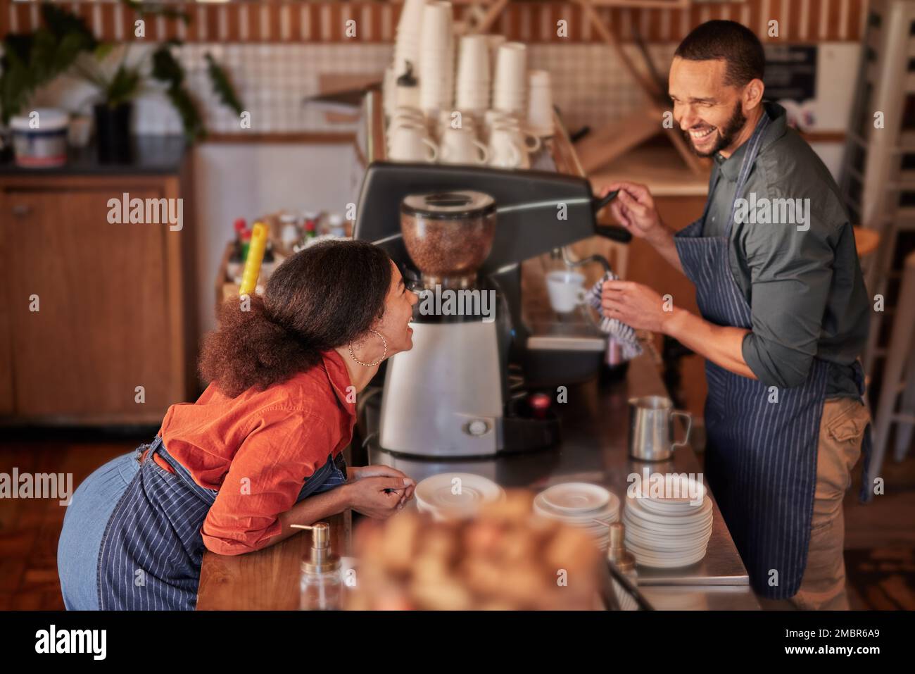 Coffee, cafe and barista couple laughing at funny meme, joke or comedy ...