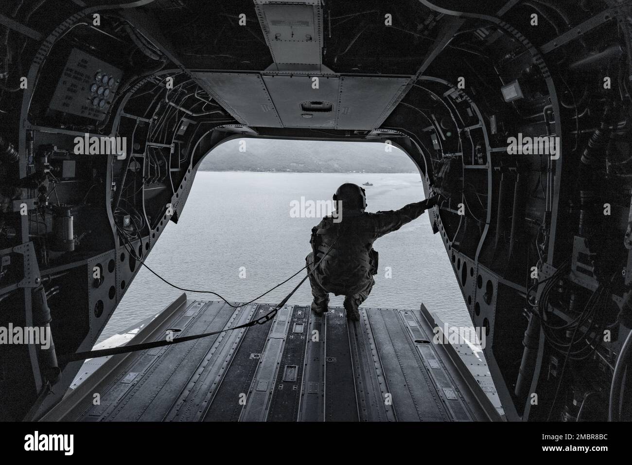 NAVAL BASE AMAPALA, Honduras - US Army loadmaster looks out the back of ...