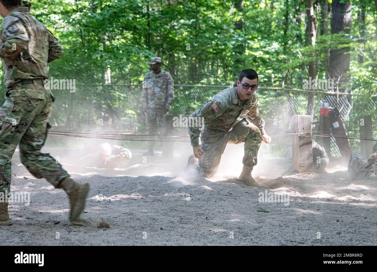 Cadets emerge from the dust after completing the low wire obstacle on ...
