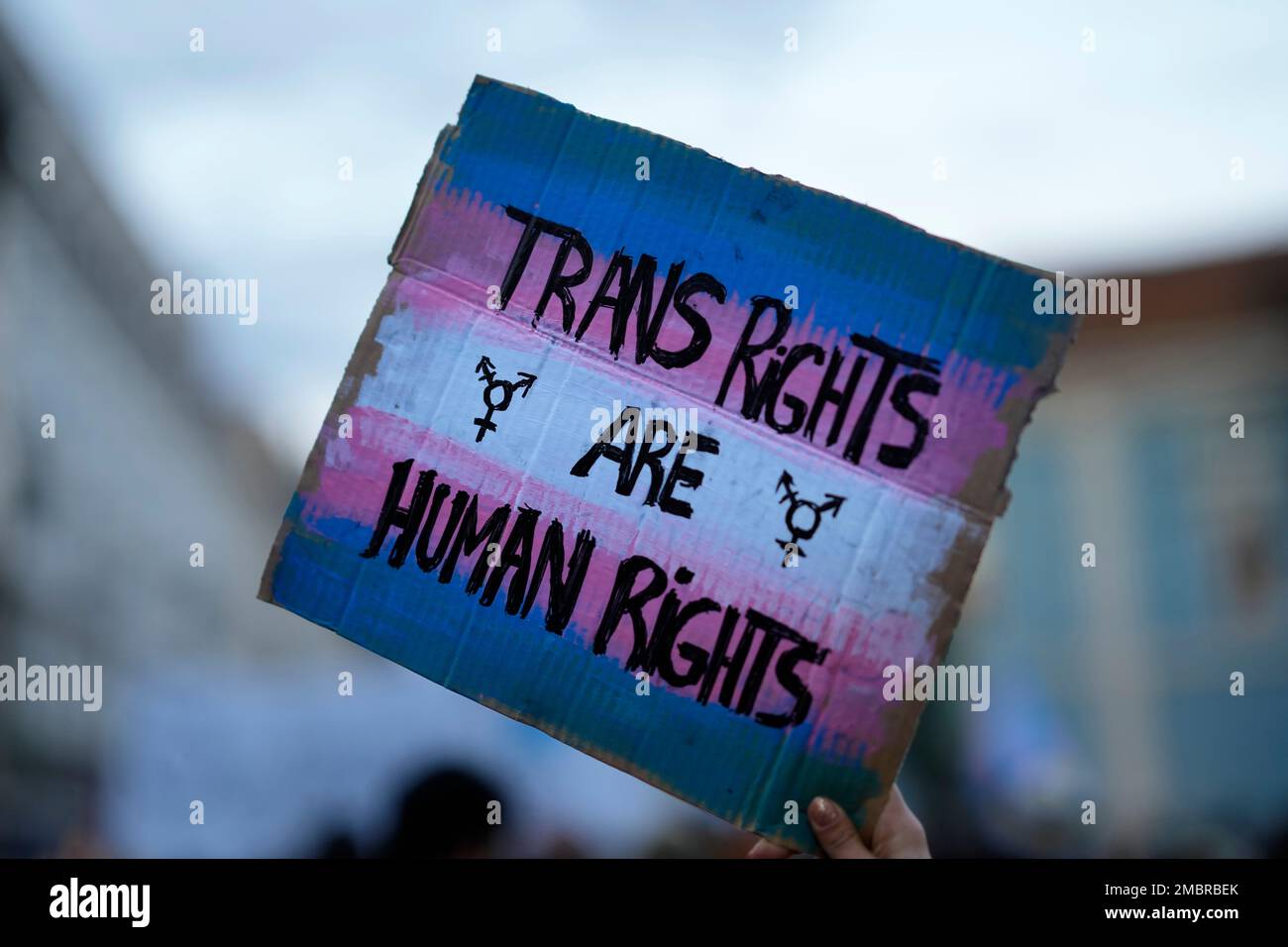 A demonstratorholds up a sign during a march to mark International ...