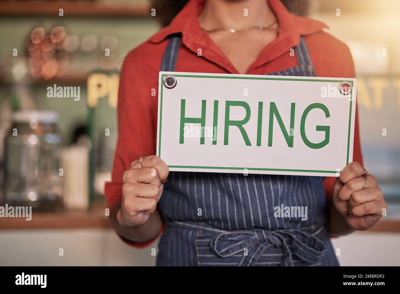 Woman looking hiring sign board hi-res stock photography and images - Alamy