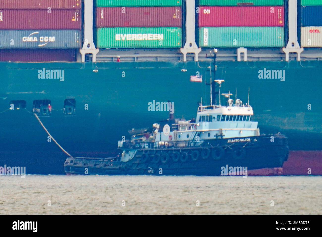 The tugboat Atlantic Salvor, bottom, pulls the container ship Ever ...