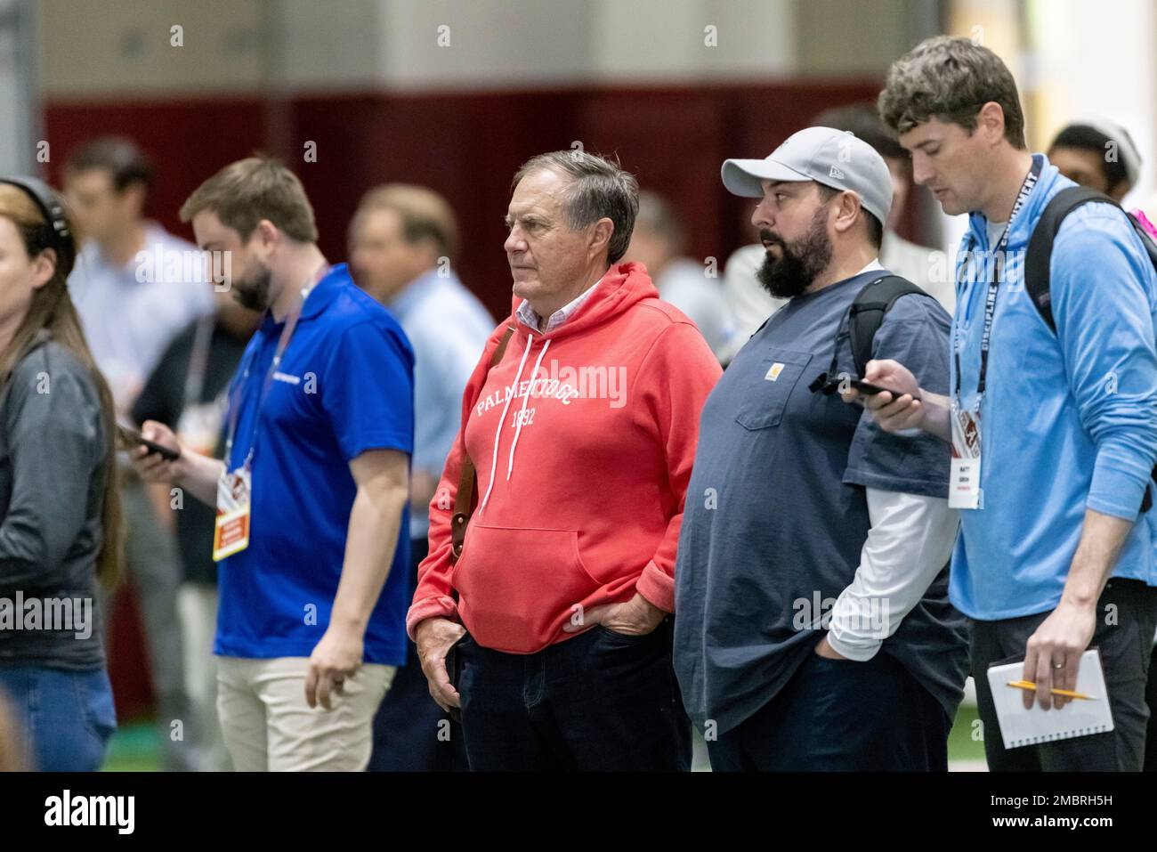 New England football coach Bill Belichick (red sweatshirt) watches at ...