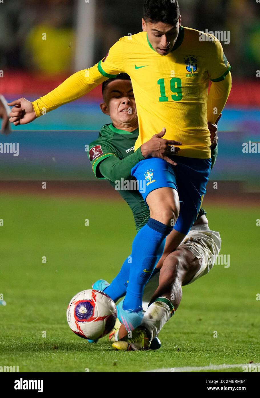 Brazil's Gabriel Martinelli is grabbed from behind by Bolivia's Franz ...