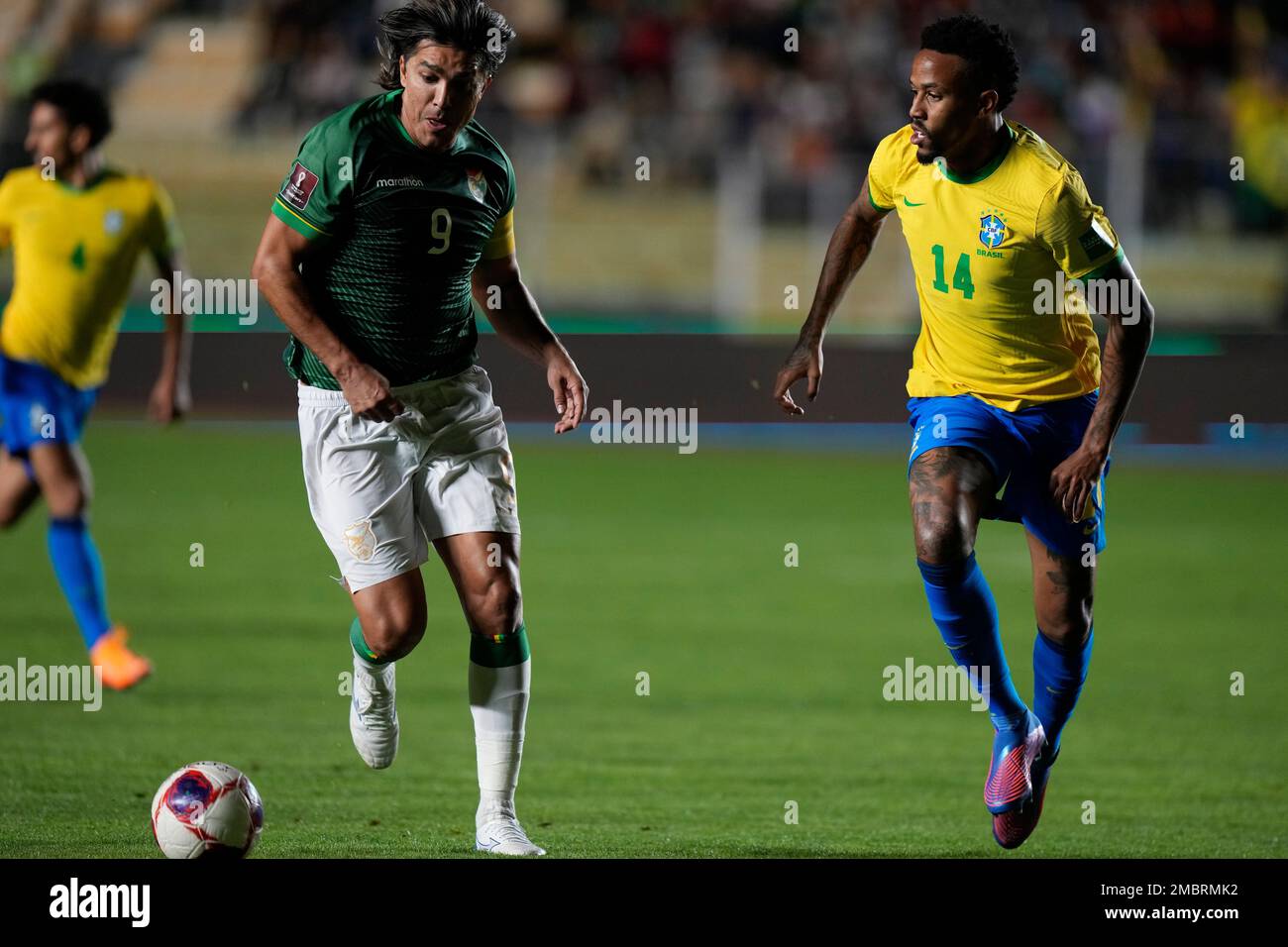 Bolivia's Marcelo Moreno, left, and Brazil's Eder Militao eye the ball ...