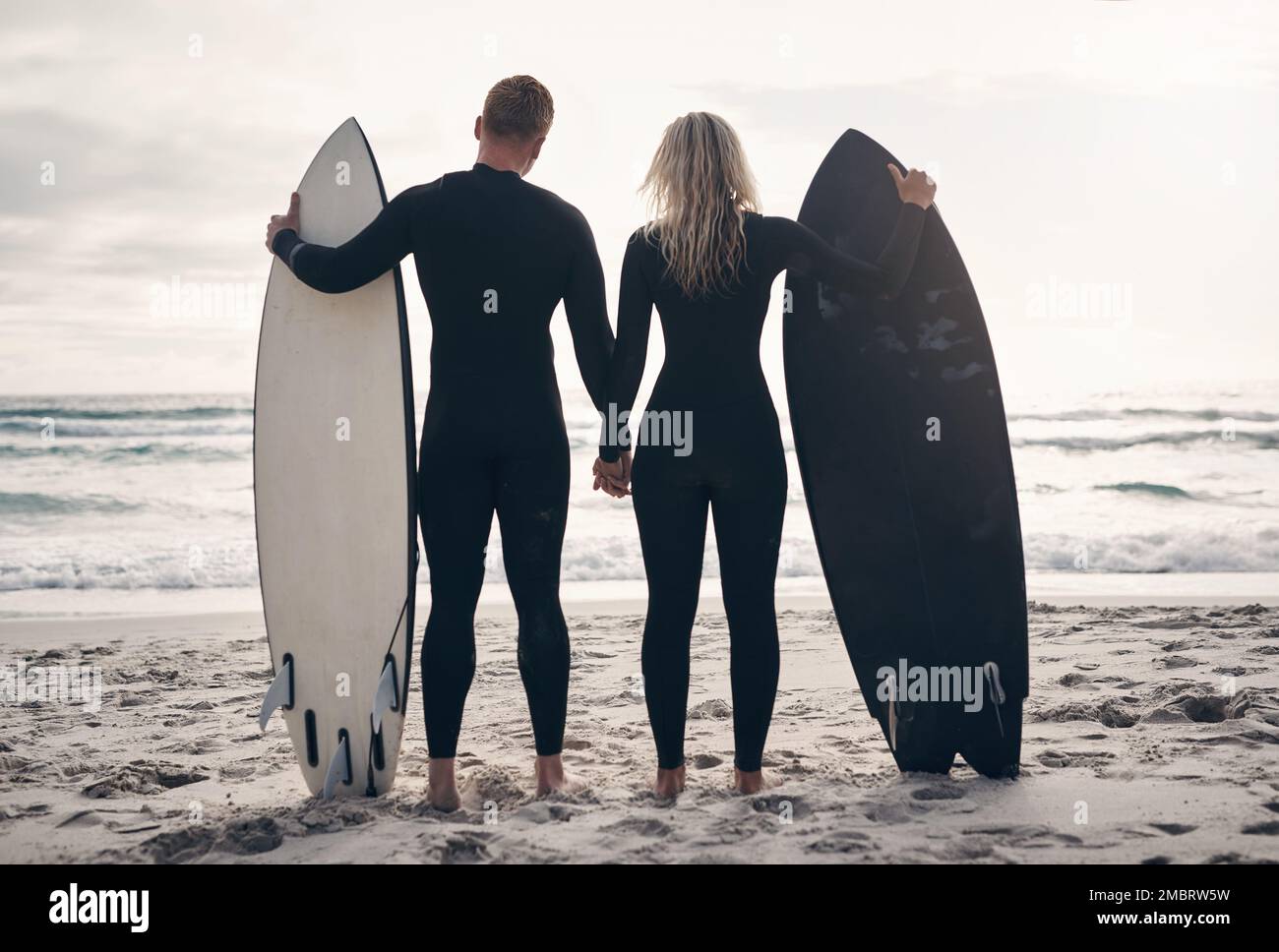 I want to surf every wave with you. a young couple standing on the ...