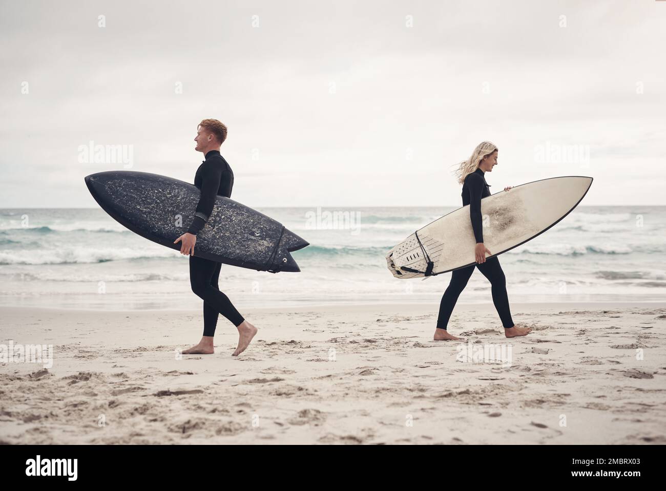 You might find your soulmate while out surfing. two people walking on ...