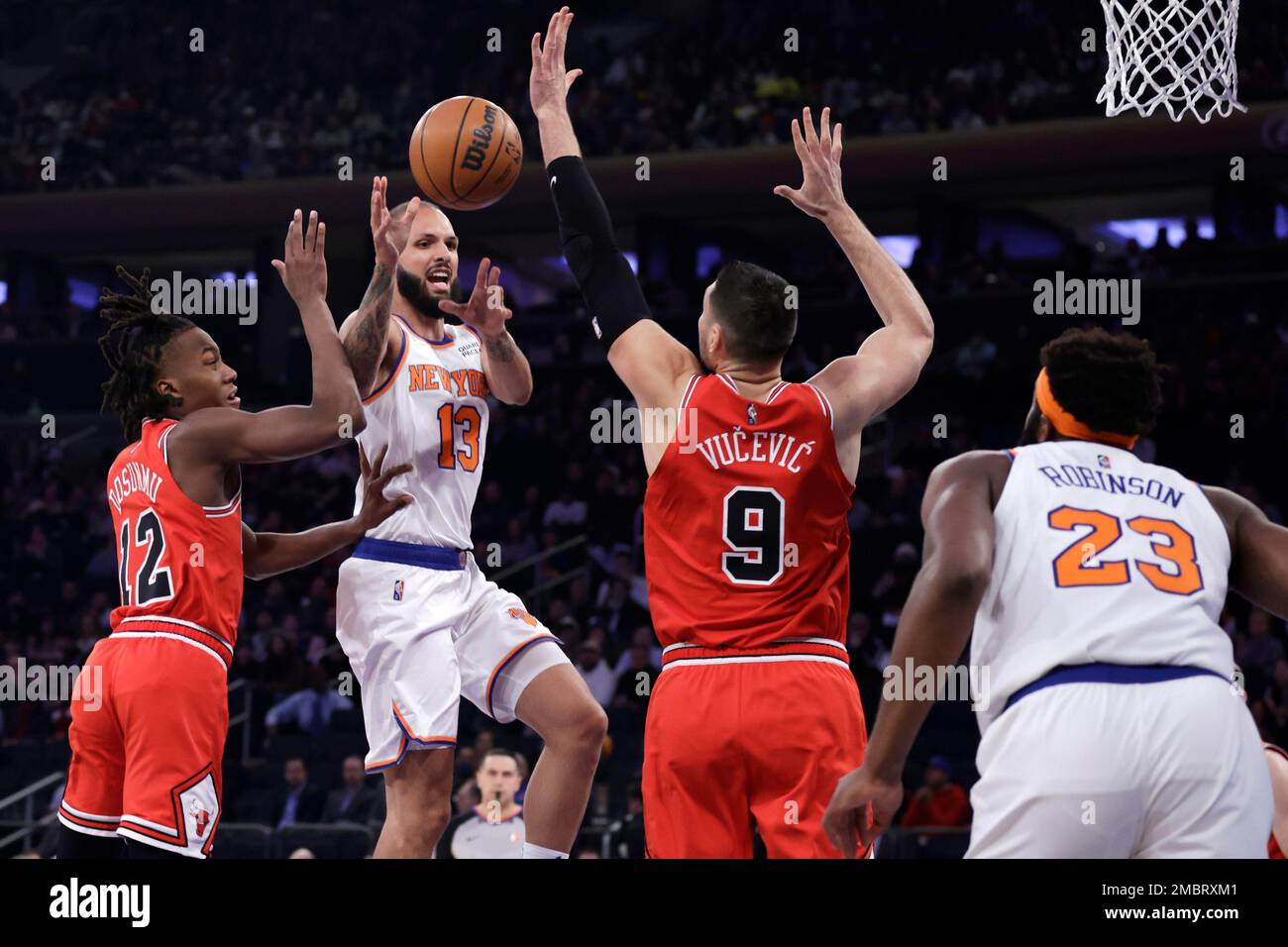 New York Knicks guard Evan Fournier (13) passes the ball between ...
