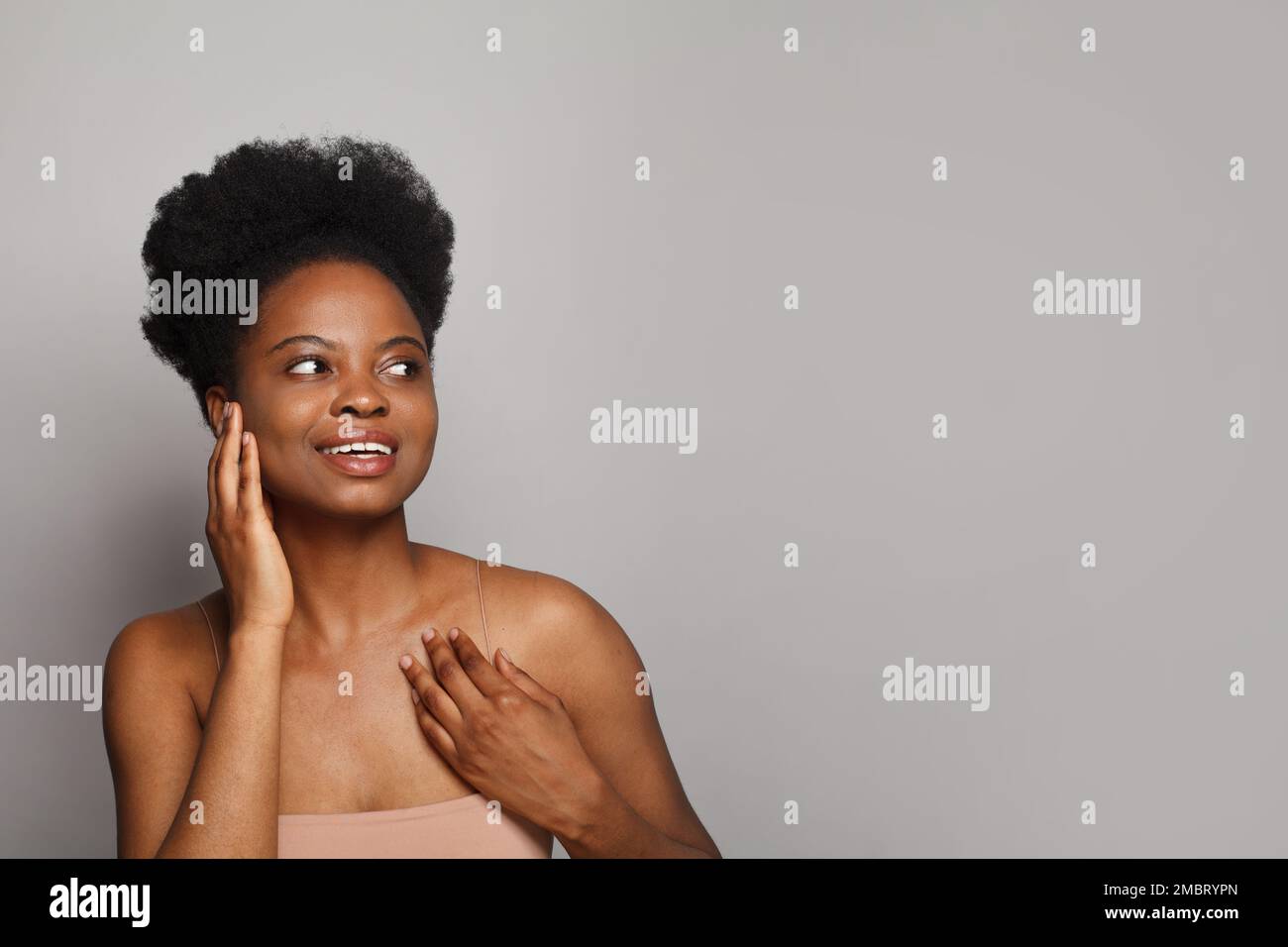 Attractive young model woman looking up on gray banner background ...