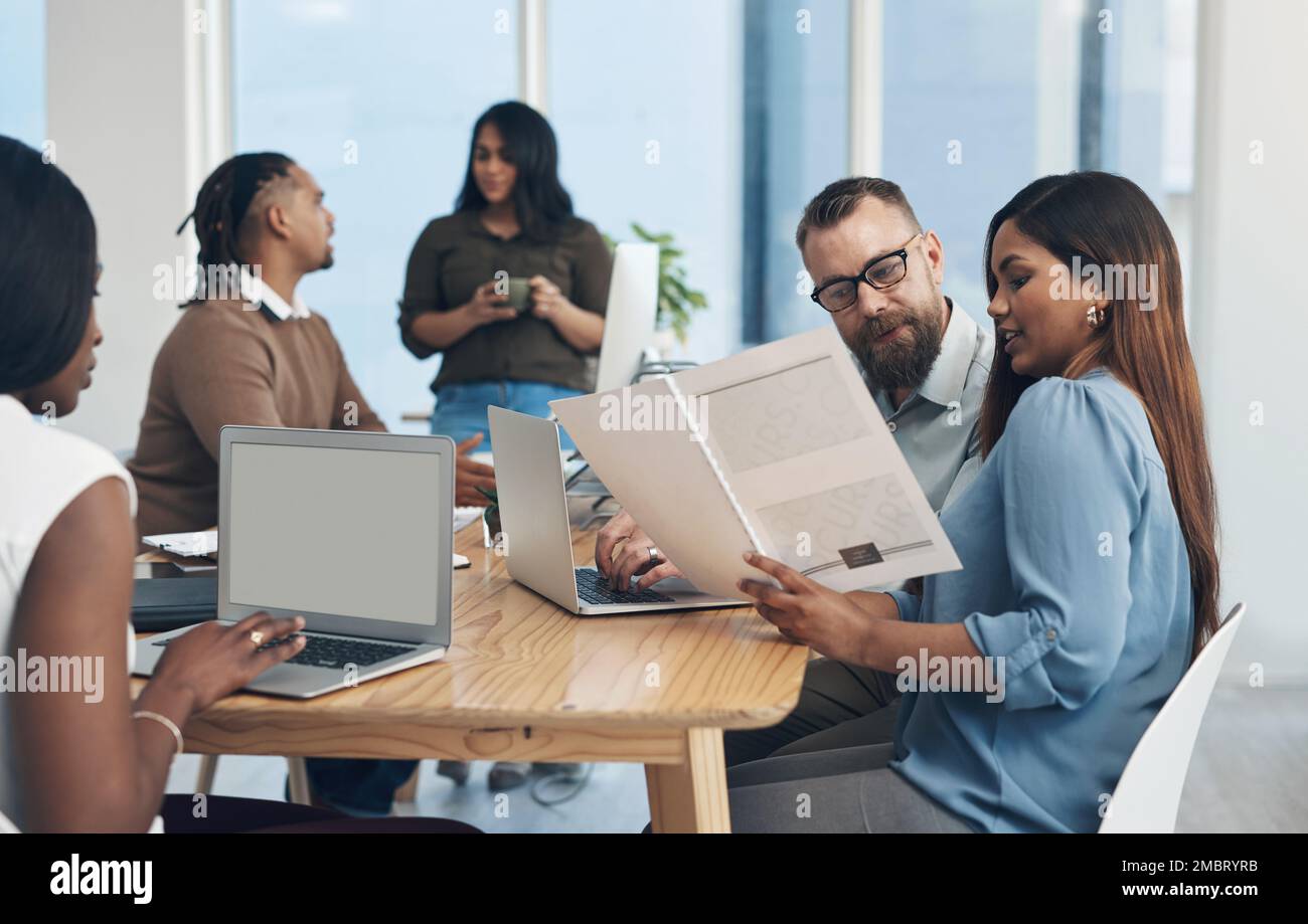 Informing the client on recent changes. two young businesspeople ...