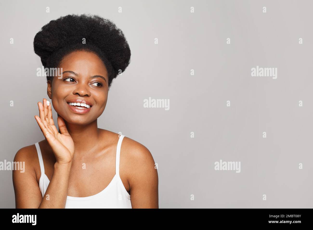 Beautiful woman applying white moisturizing cream. Cute female model ...