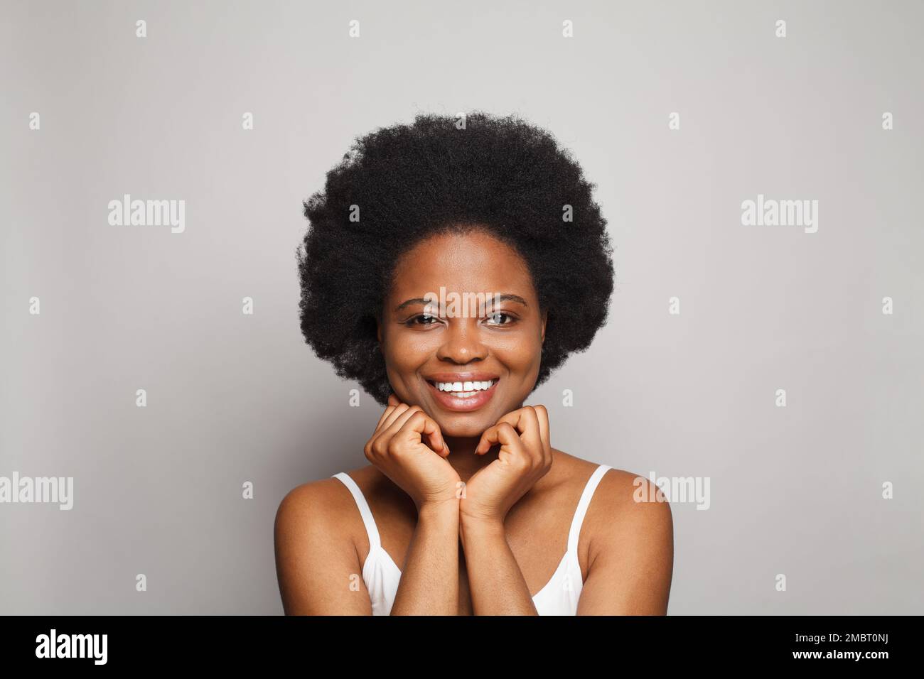 Laughing smiling model woman with dark clean fresh smooth skin portrait ...