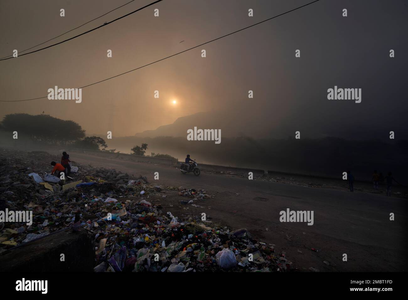 Homeless children collect garbage for reselling as a massive fire ...