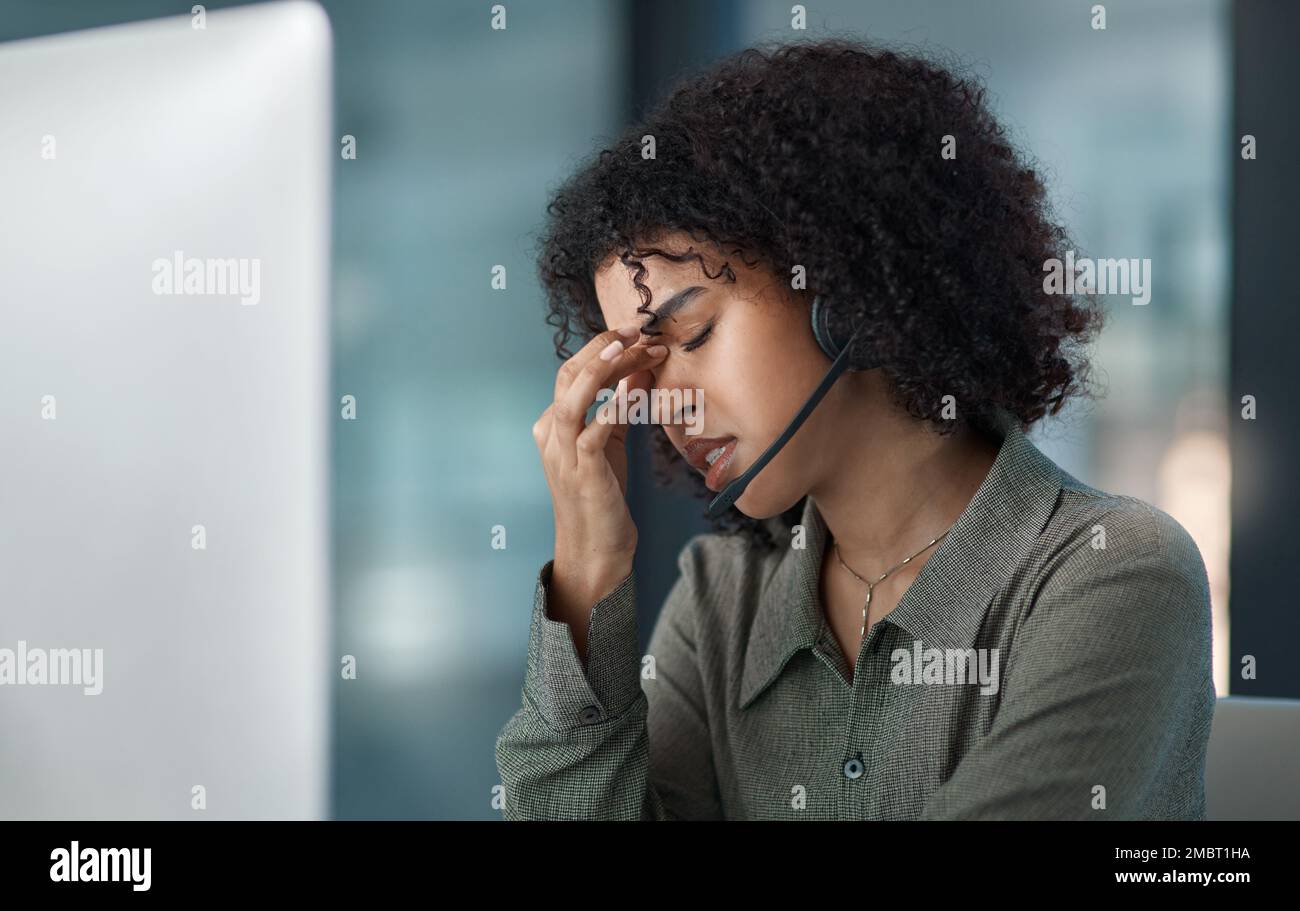 Is it Friday yet. a stressed young female agent taking a moment while ...
