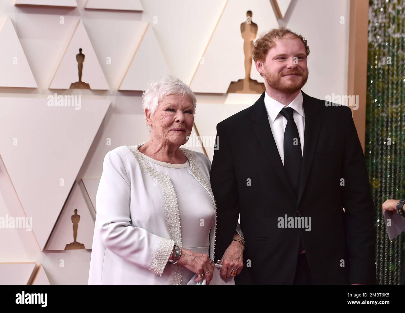Judi Dench, left, and Sam Williams arrive at the Oscars on Sunday ...