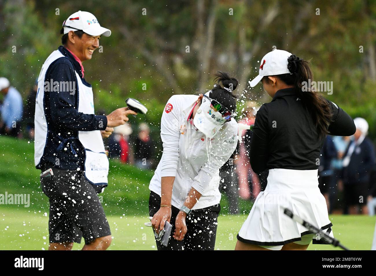 Pajaree Anannarukarn, right, douses Atthaya Thitikul, of Thailand, with champagne as her caddie ...