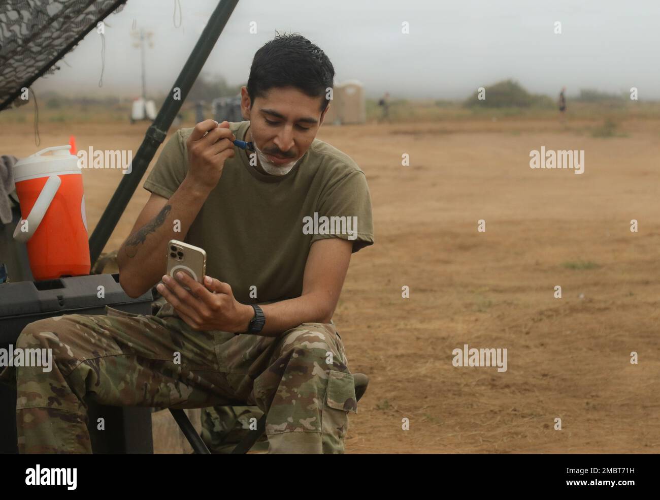 A U.S. Army Reserve Soldier conducts hygiene in the field before ...