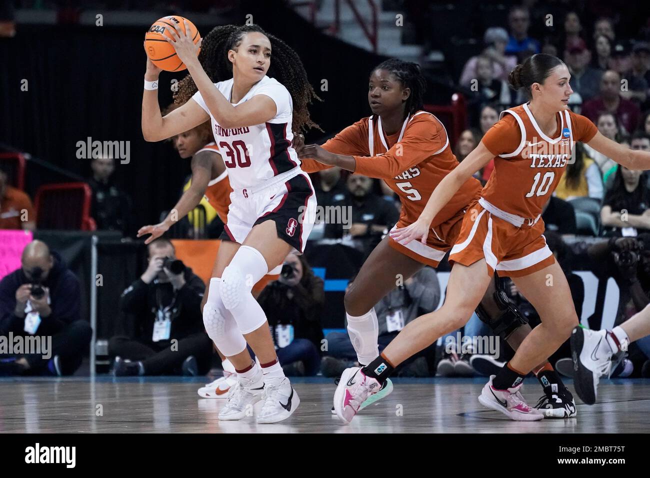 Stanford guard Haley Jones (30) looks to pass around Texas forward ...