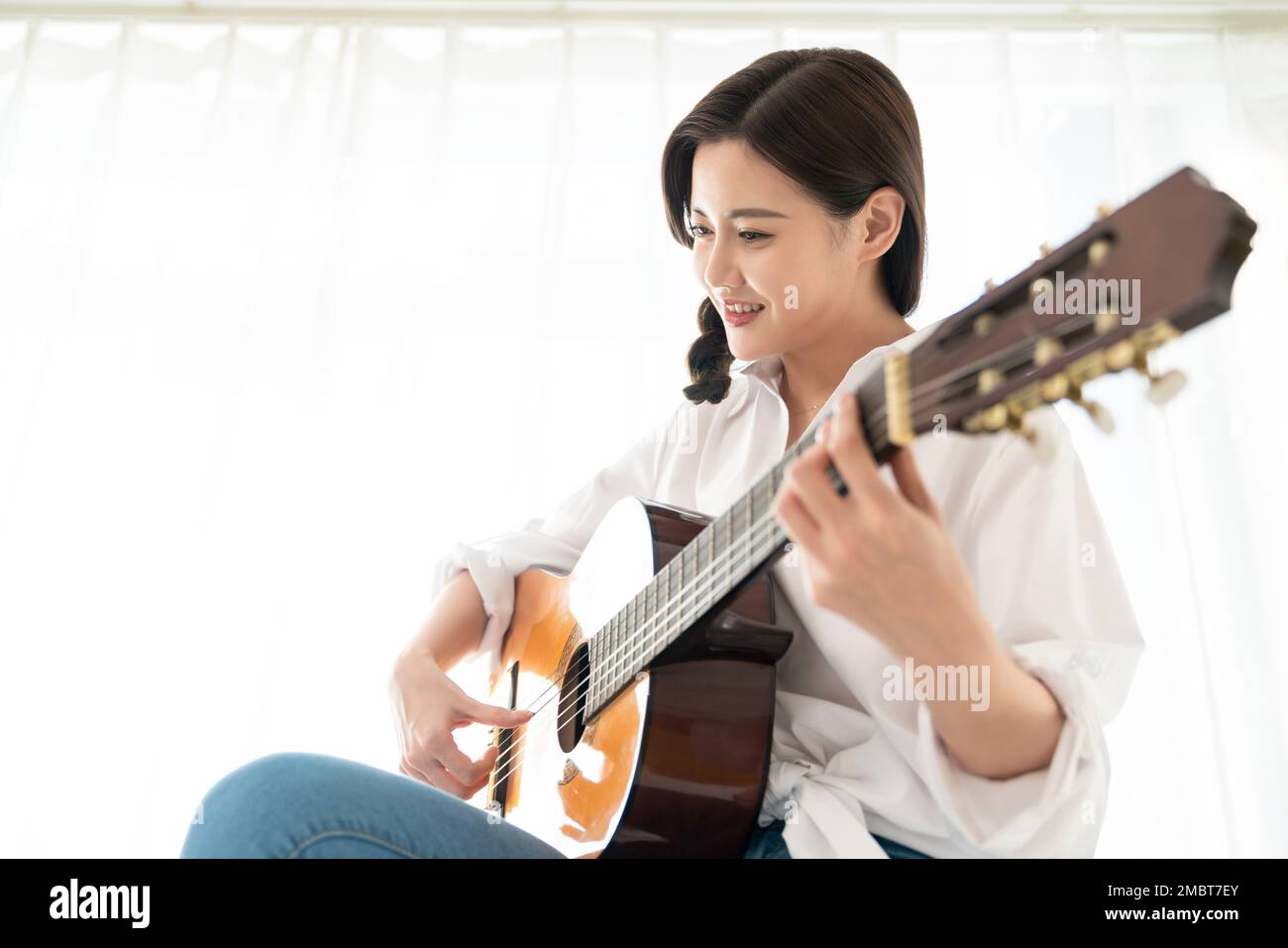 The young woman the bullet guitar Stock Photo - Alamy