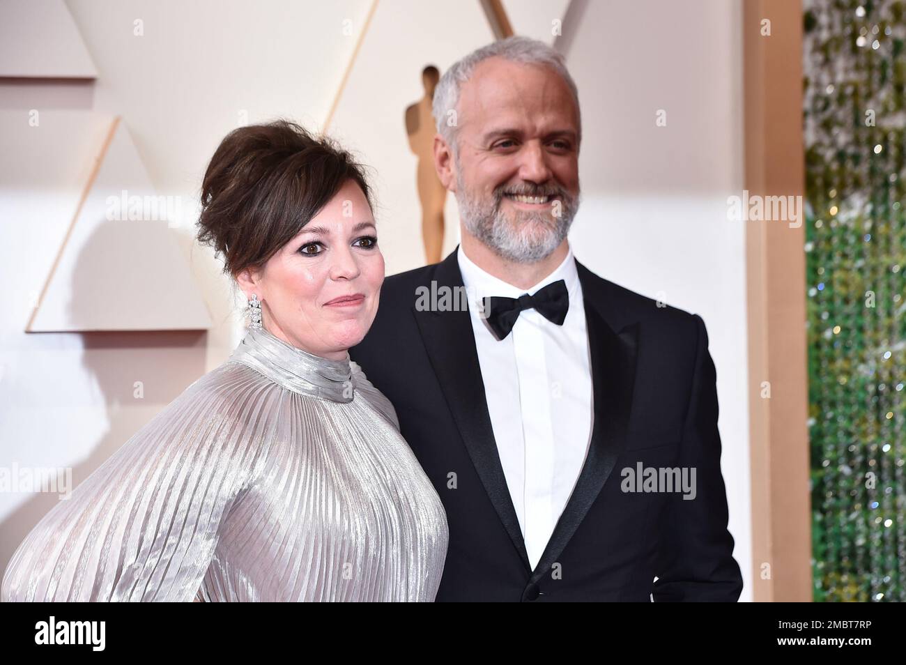 Olivia Colman, left, and Ed Sinclair arrive at the Oscars on Sunday ...