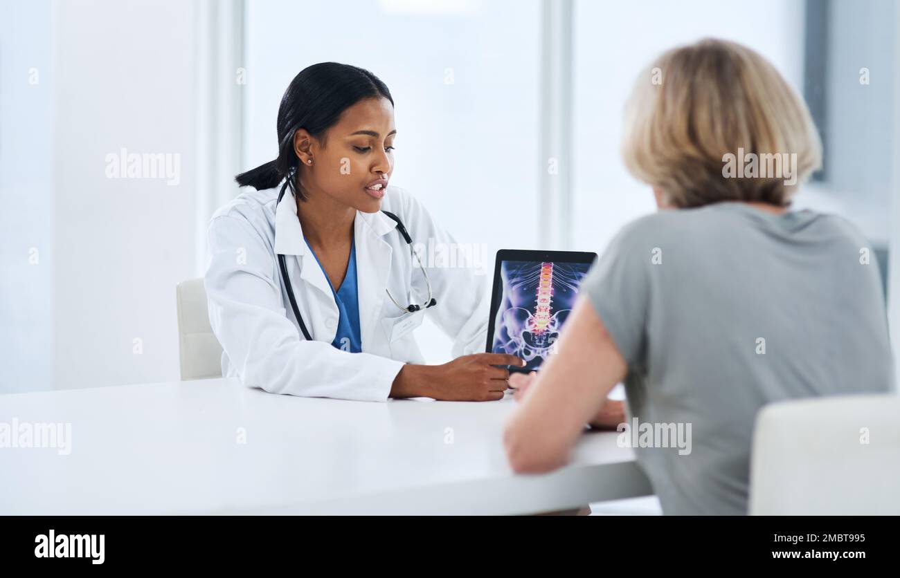 Knowledge is the cure. a young doctor using a digital tablet during a ...