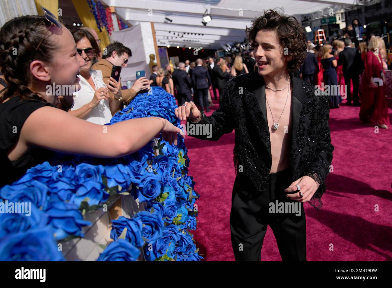 Timothee Chalamet greets fans as he arrives at the Oscars on Sunday ...