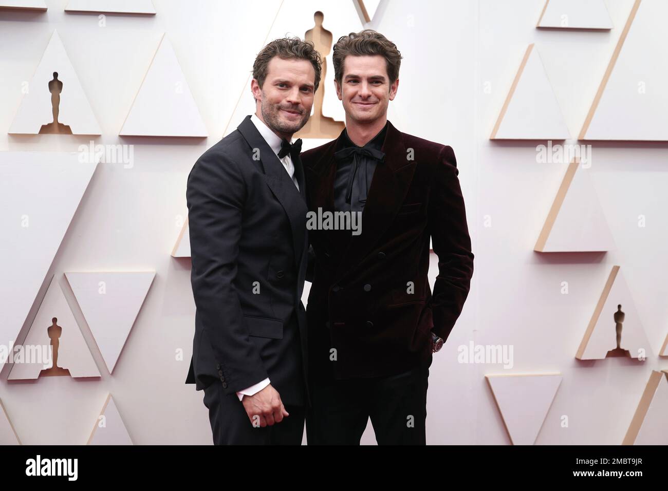 Jamie Dornan, left, and Andrew Garfield arrive at the Oscars on Sunday ...