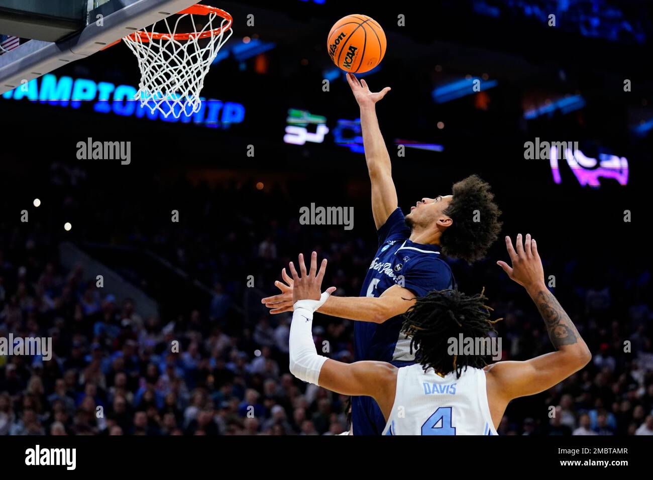 St. Peter's Daryl Banks III, top, goes up for a shot against North ...