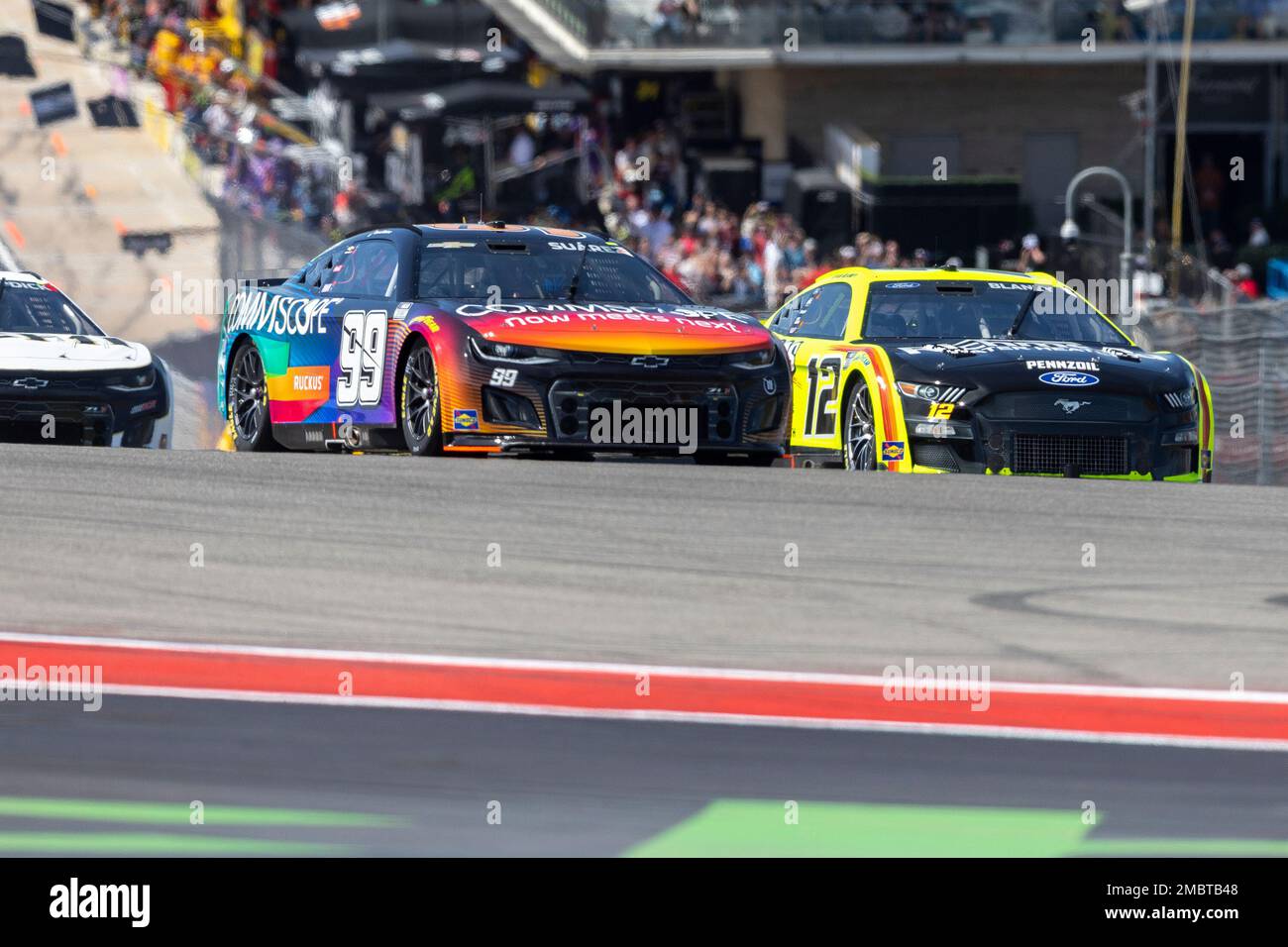 Daniel Suarez (99) with Ryan Blaney (12) steers into Turn 1 during a ...