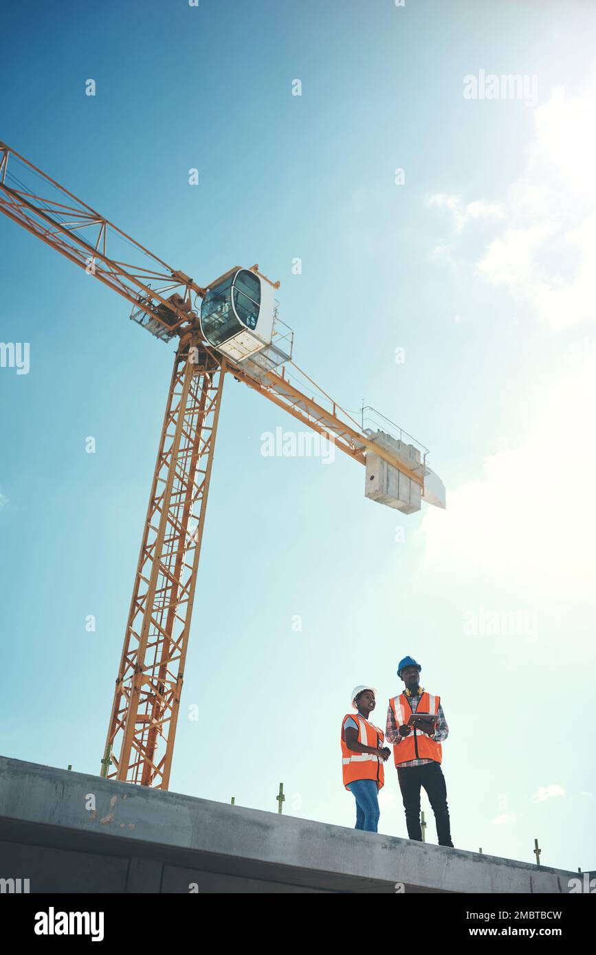 As cutting edge as construction gets. a young man and woman using a ...