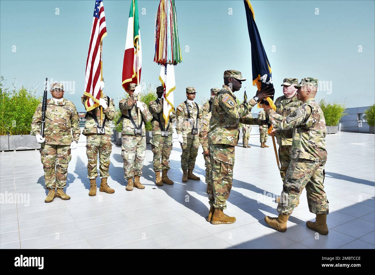 Right, Col. Miles T. Gengler, U.S. Army NATO Brigade Commander, passes ...