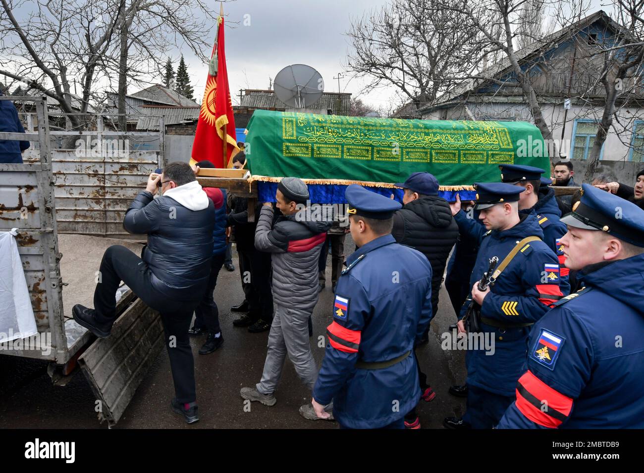 Russian servicemen stand next as people load a coffin with the body of ...