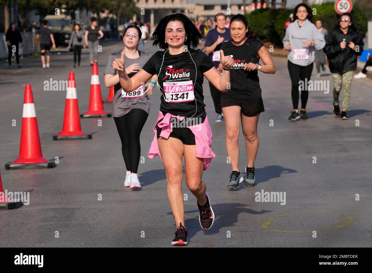 A runner cheers as she competes in the Women's Race in Beirut, Lebanon ...