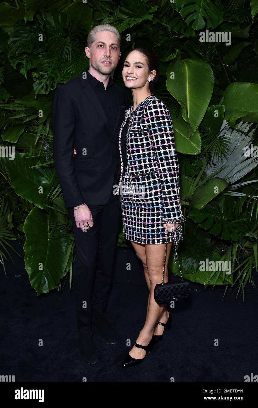 Michael Shuman, left, and Lily James arrive at the Chanel 13th annual ...