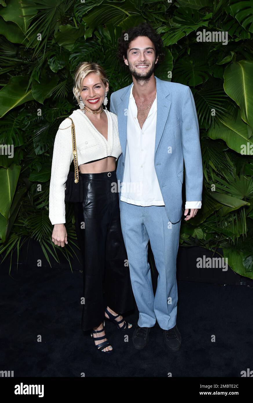 Sienna Miller, left, and Oli Green arrive at the Chanel 13th annual pre ...