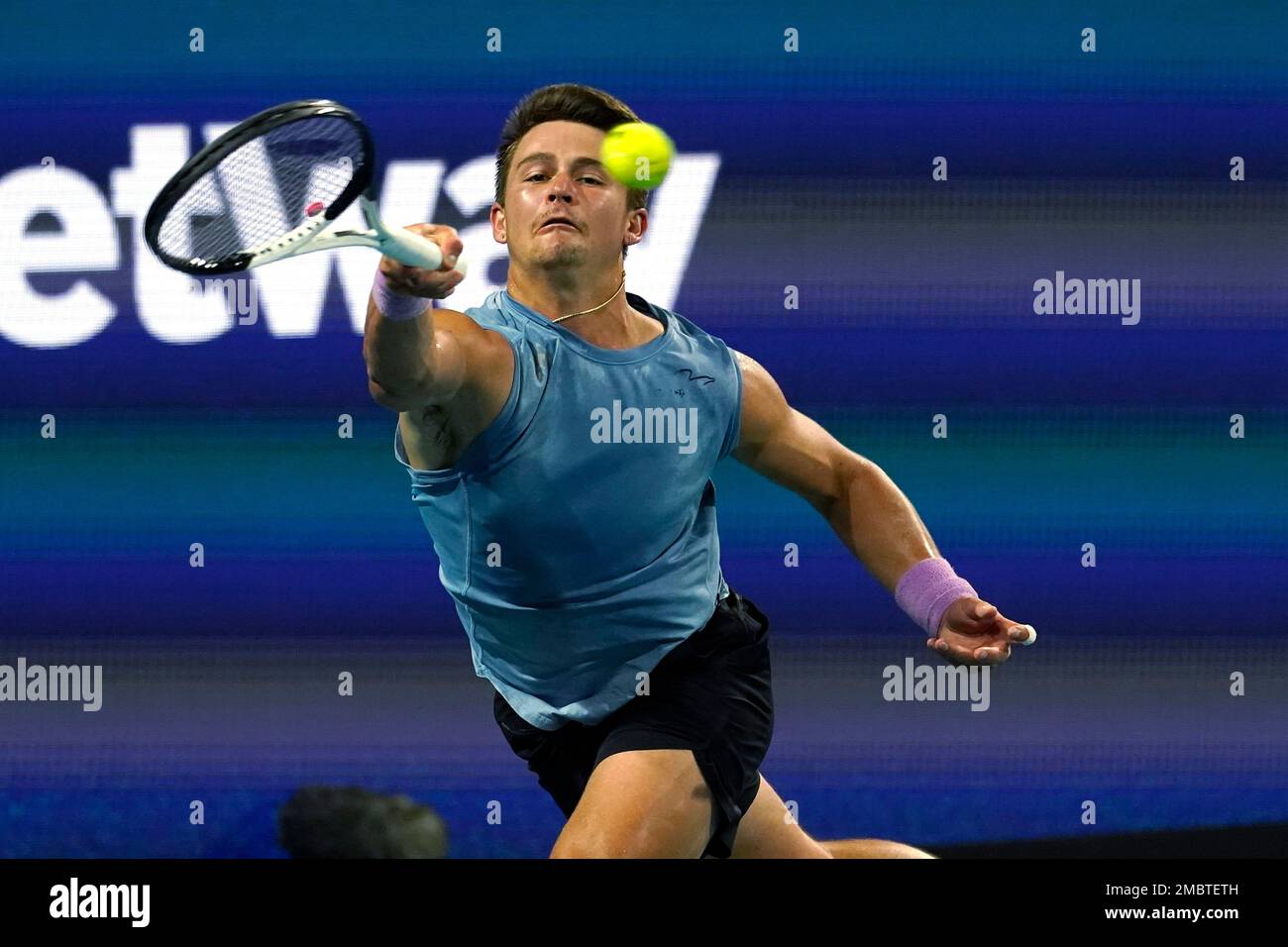 J.J. Wolf, of the United States, hits a forehand to Stefanos Tsitsipas ...