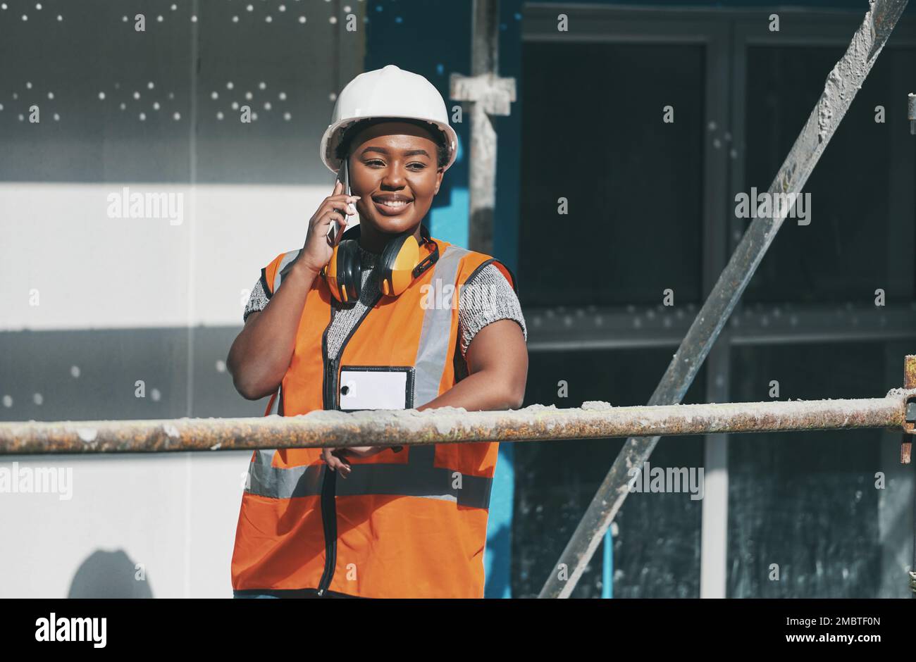 Alls going well on the new build. a young woman talking on a cellphone ...