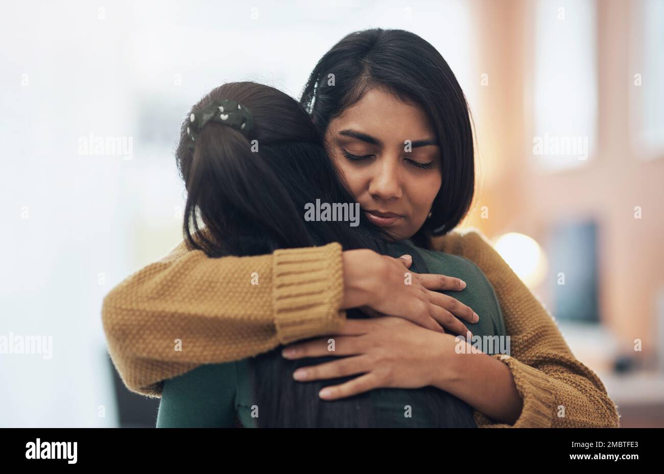 Two People Hugging And Crying