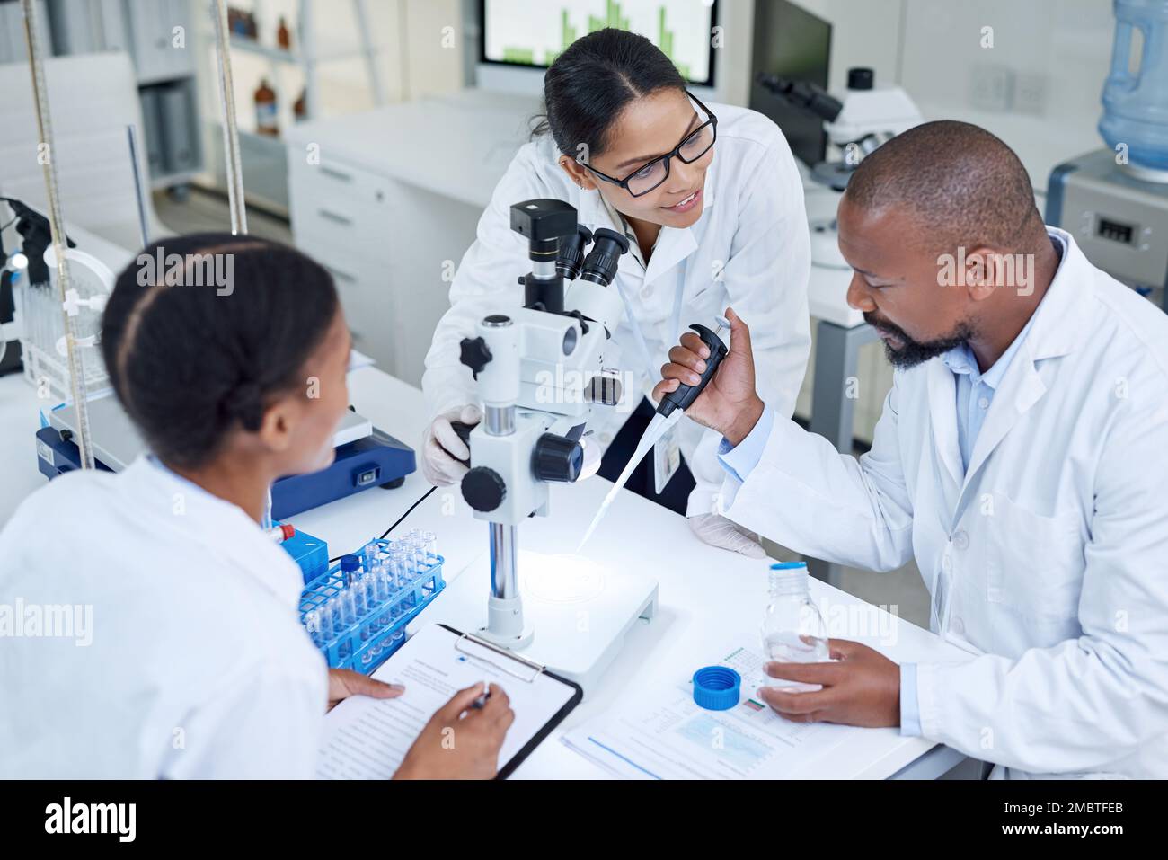 Conducting experiments to test and prove their hypothesis. a group of ...