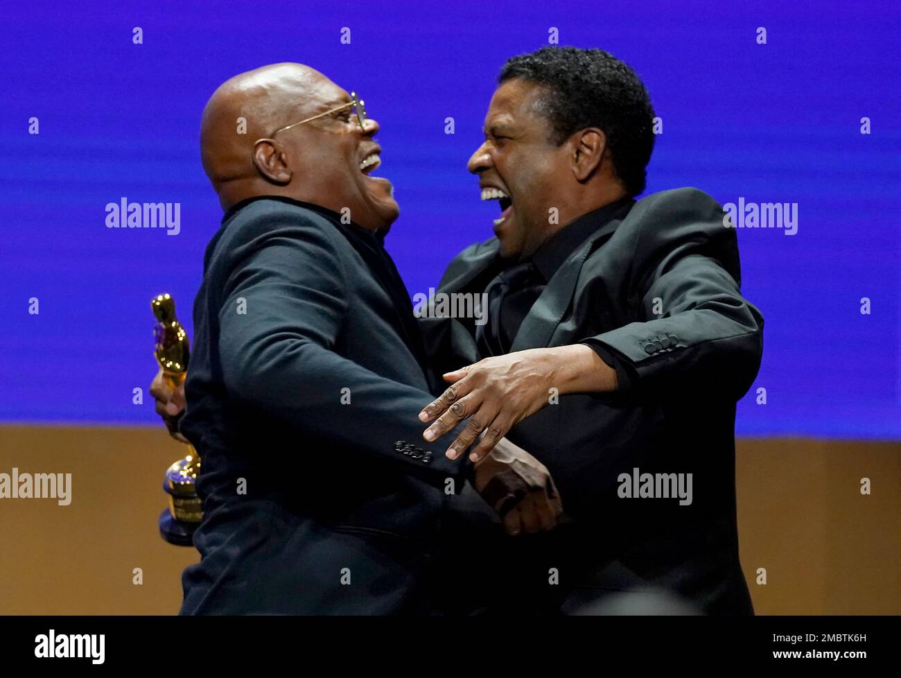 Denzel Washington, right, presents Samuel L. Jackson with an honorary ...