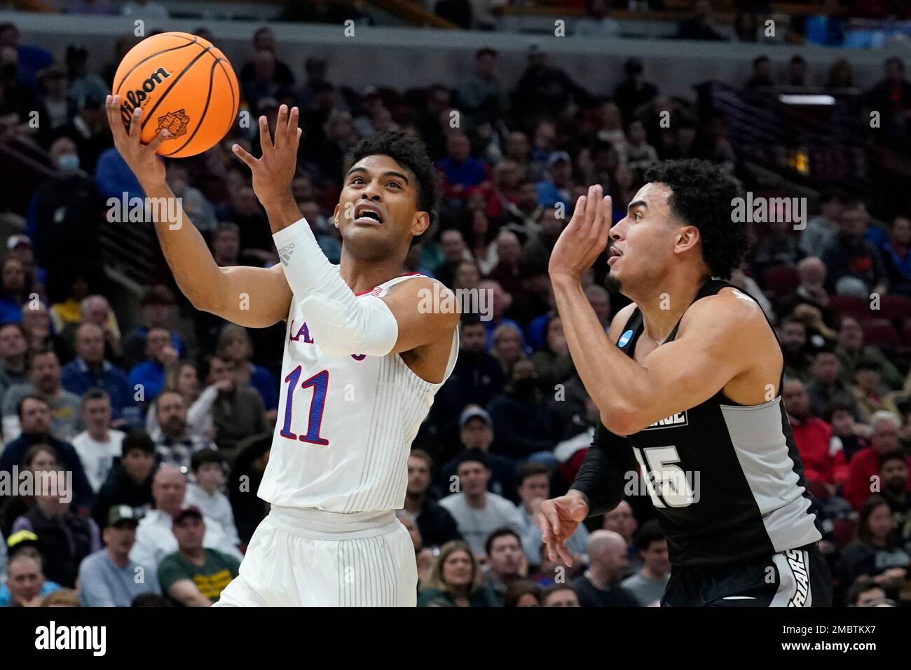 Kansas's Remy Martin shoots past Providence's Justin Minaya during the ...