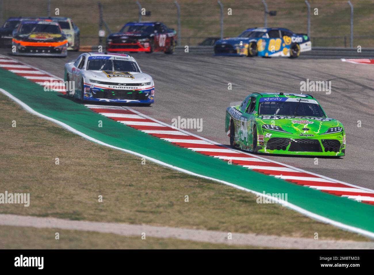 Ty Gibbs, right, drives on a straight as other cars head through Turn ...