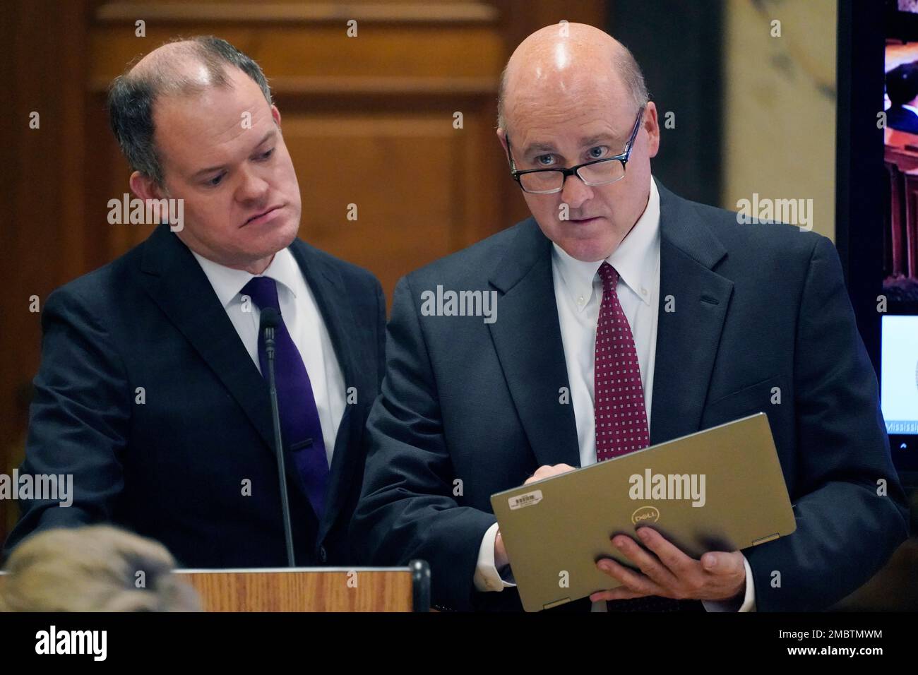 State Economist Corey Miller, left, glances at the information on the ...