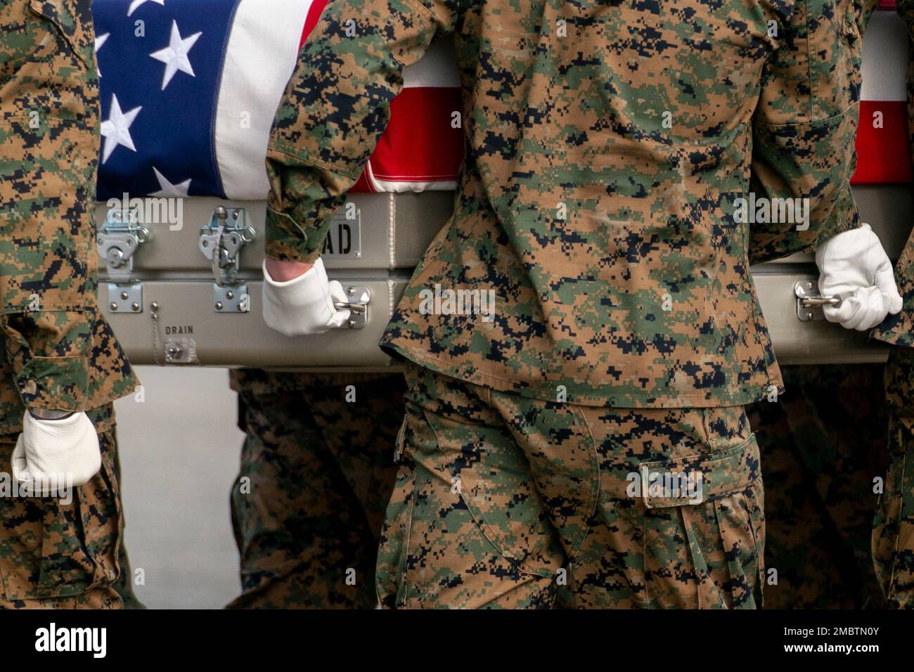 A U.S. Marine Corps carry team moves a transfer case containing the ...